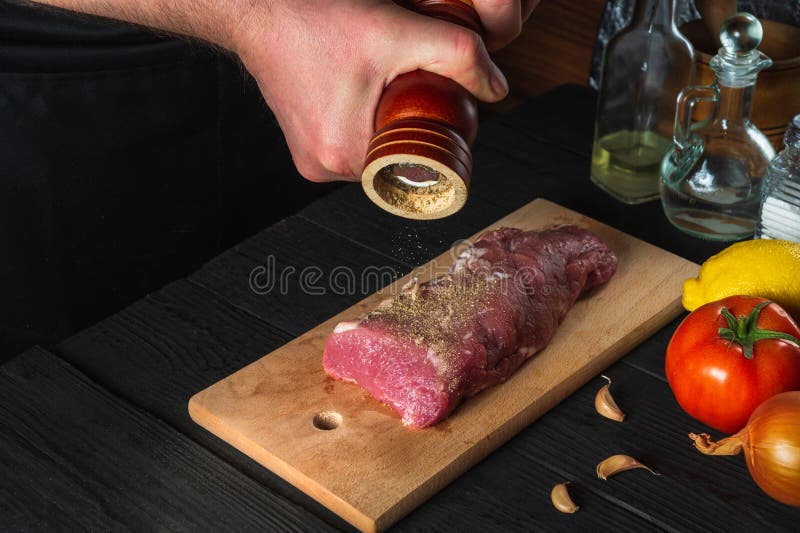 Chef Cooking Raw Meat Fillet and Adding Pepper and Chili for Marinade ...