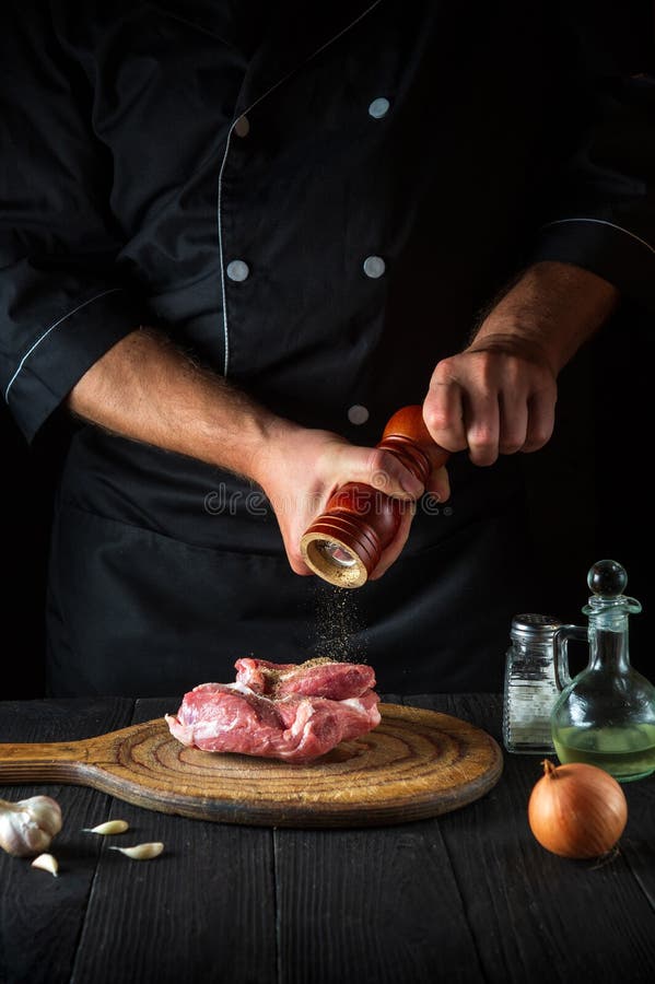 Chef Cooking Raw Meat Fillet and Adding Pepper or Chili for Marinade ...