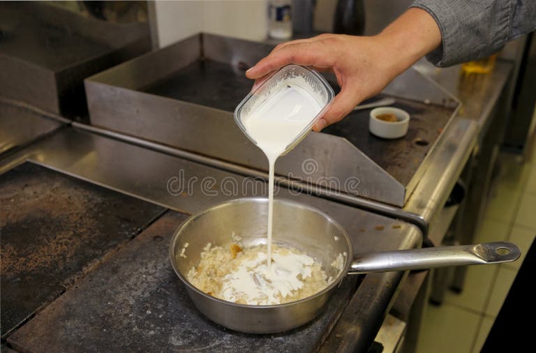 Chef is cooking risotto stock image. Image of rice, mixing - 25128223