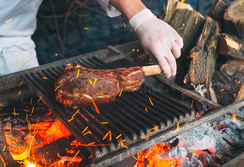 Chef Cooking Steak. Cook Turns the Meat on the Fire. Stock Photo ...