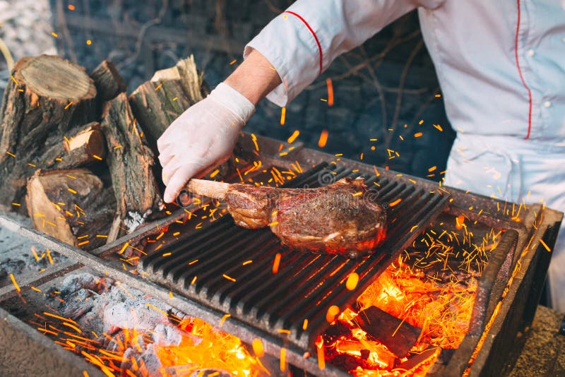 Chef Cooking Steak. Cook Turns the Meat on the Fire. Stock Image ...
