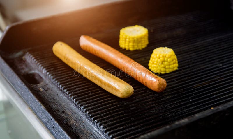 The Chef Cooking Two Hot Dogs on a Grill. Restaurant Stock Image ...