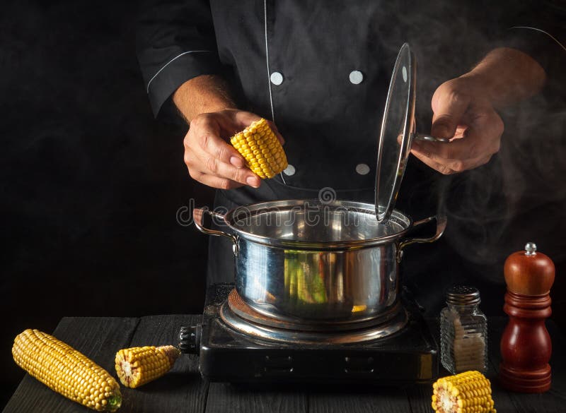 Chef Cooks Corn. Close-up of a Cook Hands while Cooking in a Restaurant ...