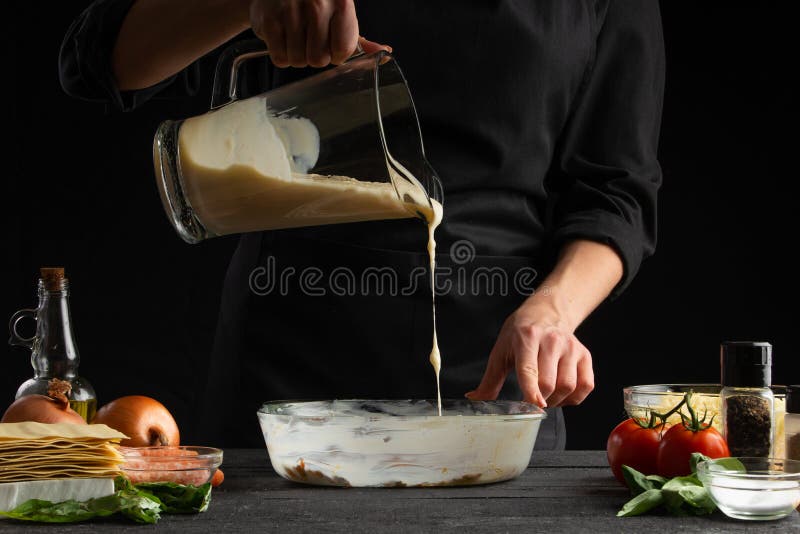 Chef Cooks Italian Lasagna, Pouring Bechamel Sauce Stock Image - Image ...