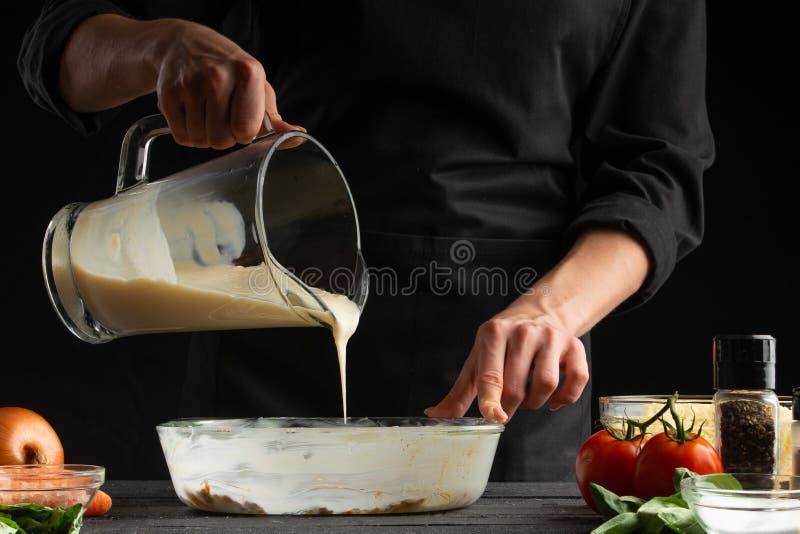 Chef Cooks Italian Lasagna, Pouring Bechamel Sauce Stock Image - Image ...