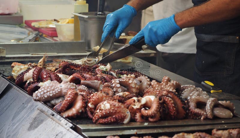 A Chef Cooks Octopuses on a Grill Plate in the Seafood Restaurant Stock ...