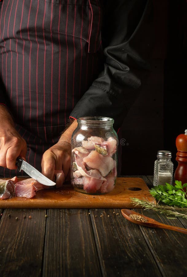 The Chef Cuts the Fish into Steaks before Preparing the Herring in a ...