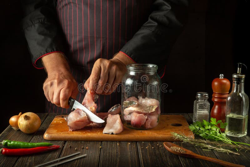 The Chef Cuts the Fish into Steaks before Preparing the Herring in a ...