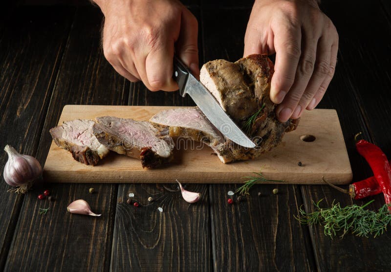 The Chef Cuts the Grilled Veal Meat into Small Slices. Work Environment ...