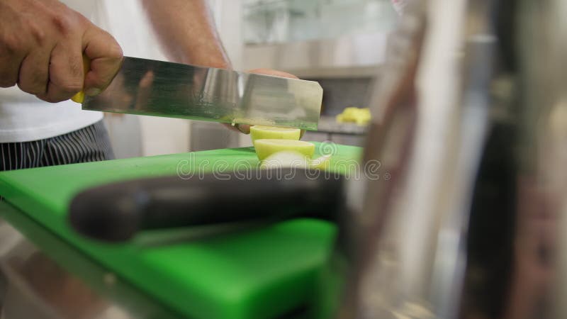 Chef Cuts Lemon on a Chopping Board at a Restaurant Stock Video - Video ...