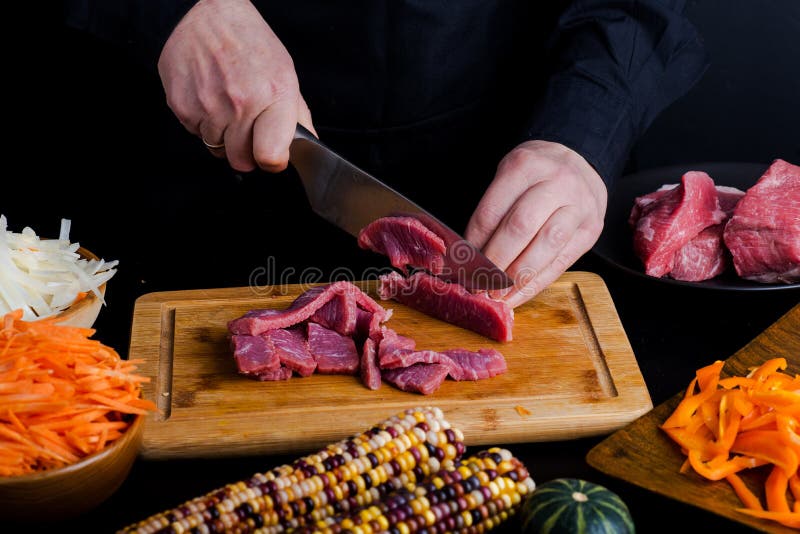 Hands of the Chef Cut Meat on the Black Table Stock Image - Image of ...