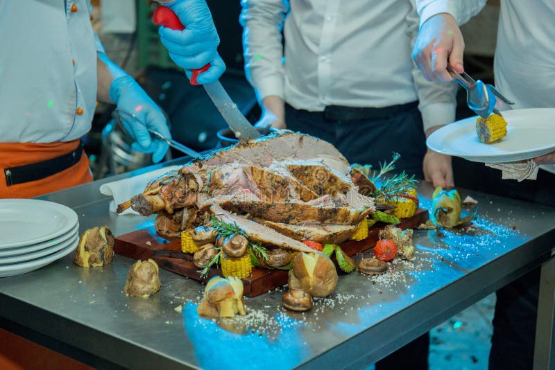 Chef Cuts Meat on Fire Flambe Ham with a Knife Stock Photo - Image of ...