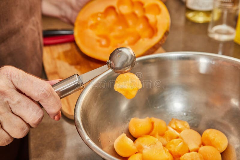 Chef Cuts Melon Balls with Special Spoon in Kitchen Stock Photo - Image ...