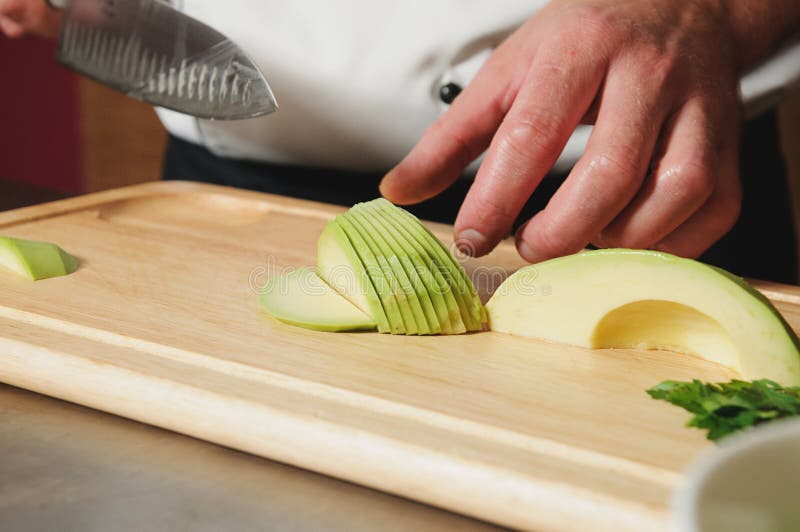 Chef Cutting Avocado on Table Stock Image - Image of fruit, yellow ...