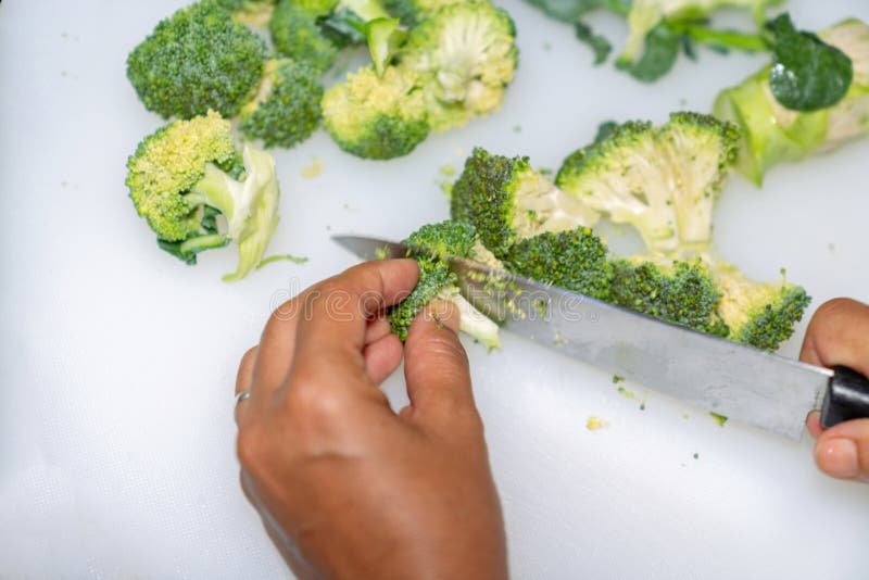 Chef Cutting Broccoli on a White Cutting Board Stock Image - Image of ...