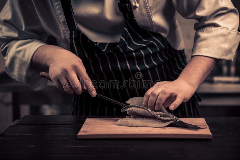 Chef Cutting the Fish on a Board Stock Photo - Image of knife, kitchen ...