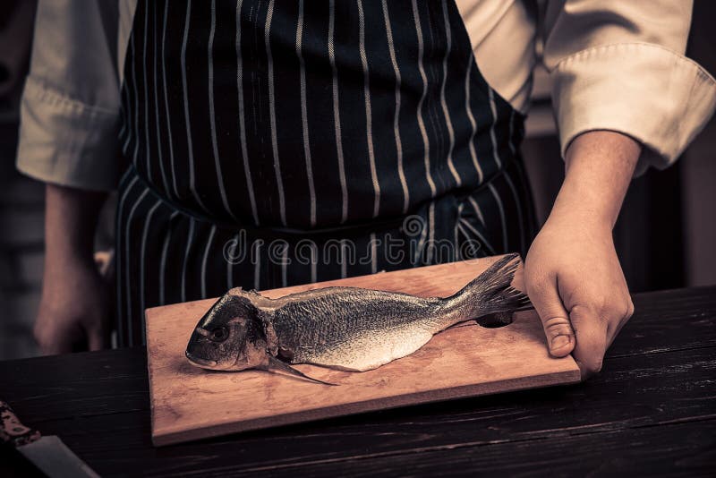 Chef Cutting the Fish on a Board Stock Photo - Image of oven, cooker ...