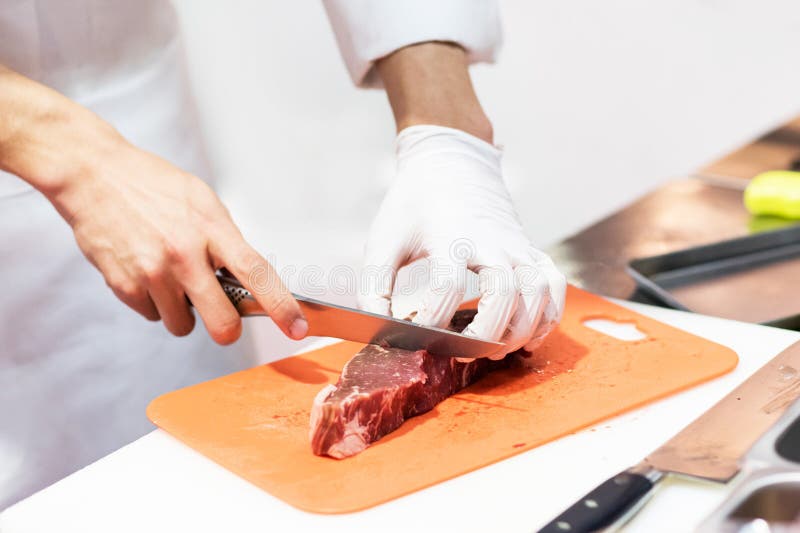Chef Cutting Fresh Raw Meat with Knife in the Kitchen, Chef Cutting ...