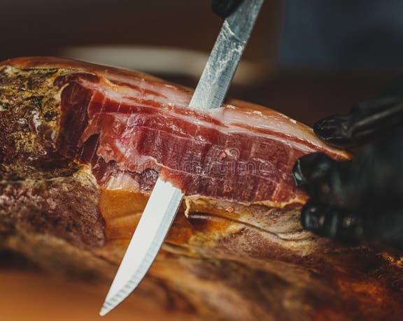 Chef cutting ham Jamon stock photo. Image of iberico - 261609300