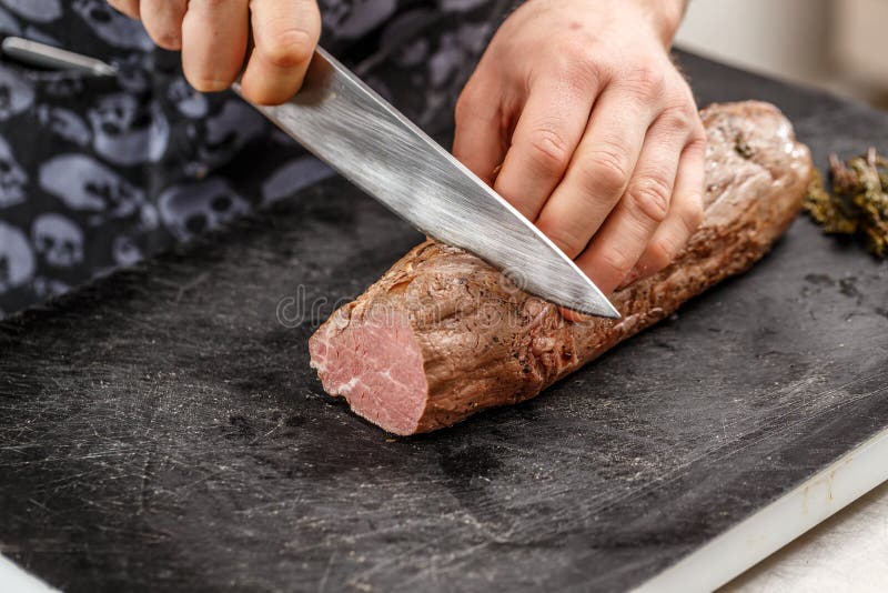 Chef is cutting meat stock image. Image of beef, hand - 89145045