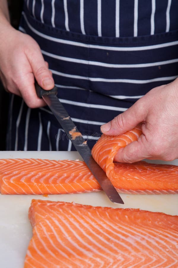 Chef cutting salmon fish stock image. Image of person - 16939105