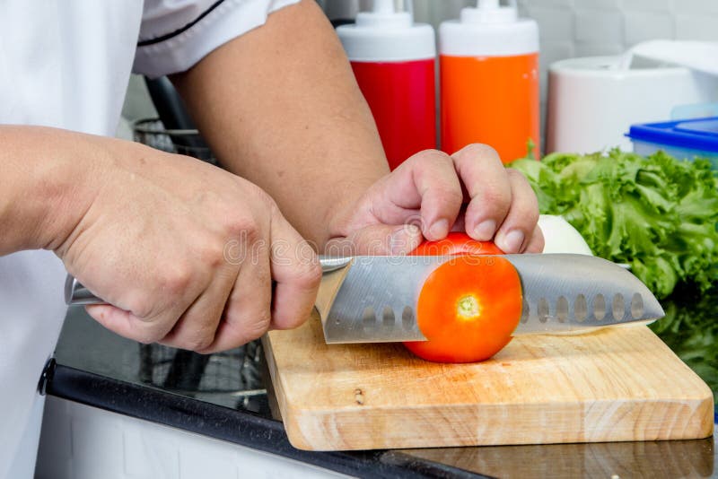 Chef cutting tomato stock image. Image of breakfast, kitchen - 55843569