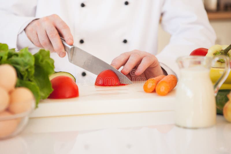 Chef Cutting a Tomato stock image. Image of knife, food - 34875817