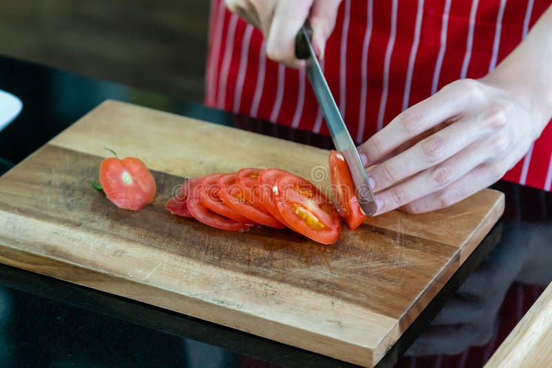 Chef is Cutting Tomatoes in the Kitchen. Take a Close-up Shot of the ...