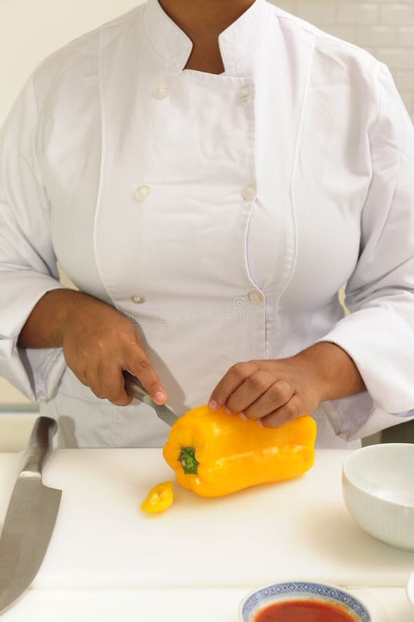 Chef cutting yellow pepper stock photo. Image of indoor - 12937734