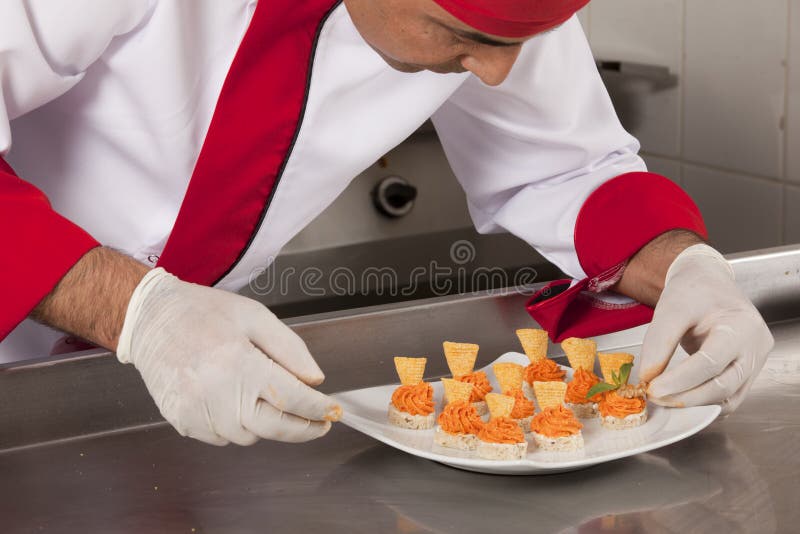 Chef Decorating canapes stock image. Image of indoor - 26395785