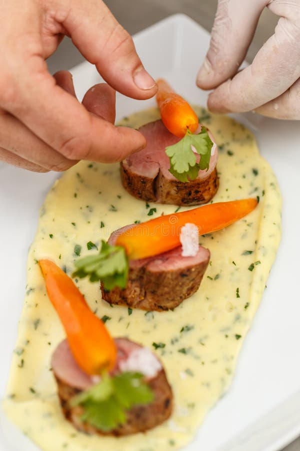 Chef decorating meat plate stock photo. Image of gourmet - 77068548