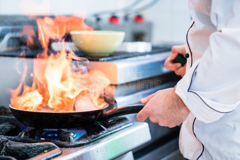Chef Doing Flambe To Dish in Pan Stock Image - Image of chef ...