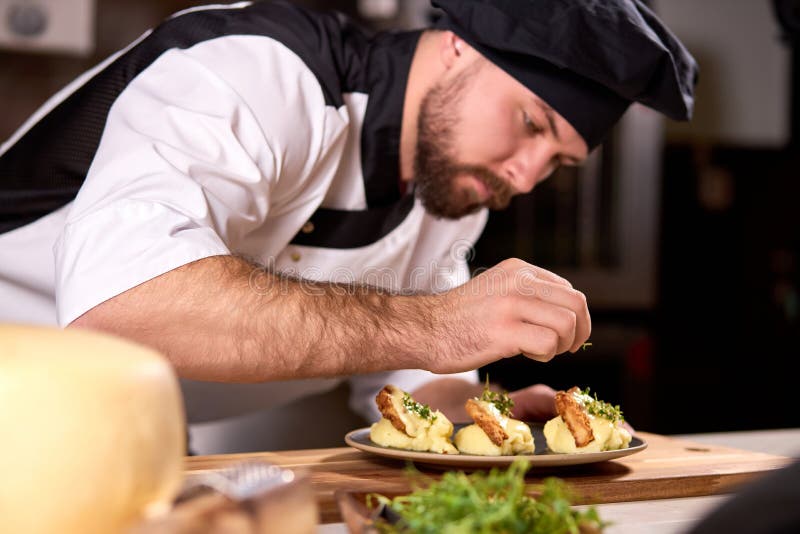 Chef Dressing Salad with Greens, Adding Some Ingredients Stock Photo ...
