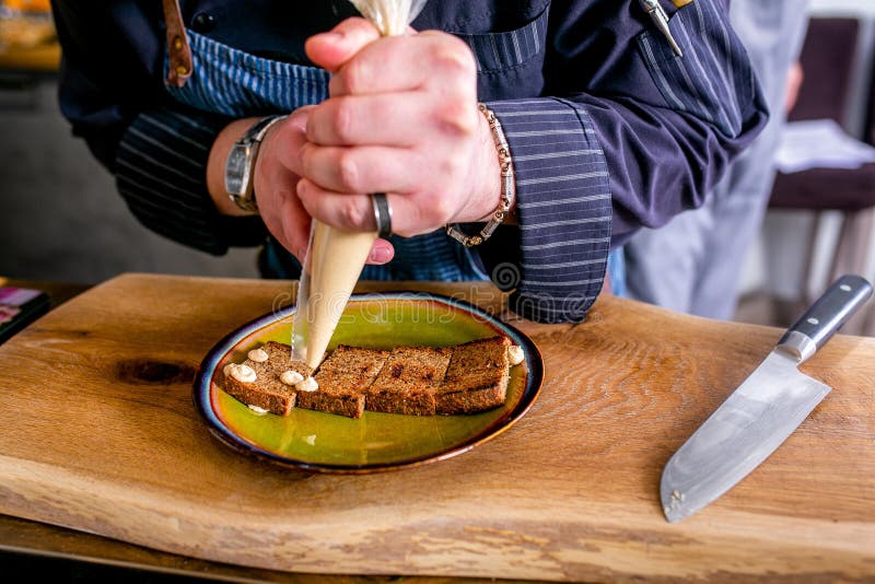 Chef Dressing Slices of Roasted Bread. Master Class in the Kitchen. the ...