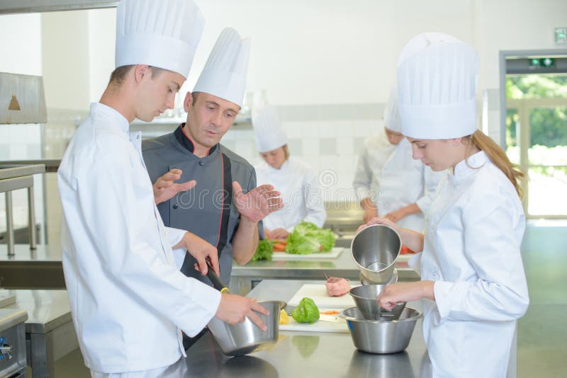 Chef Explaining To Trainees Stock Photo - Image of youth, whisk: 202443302