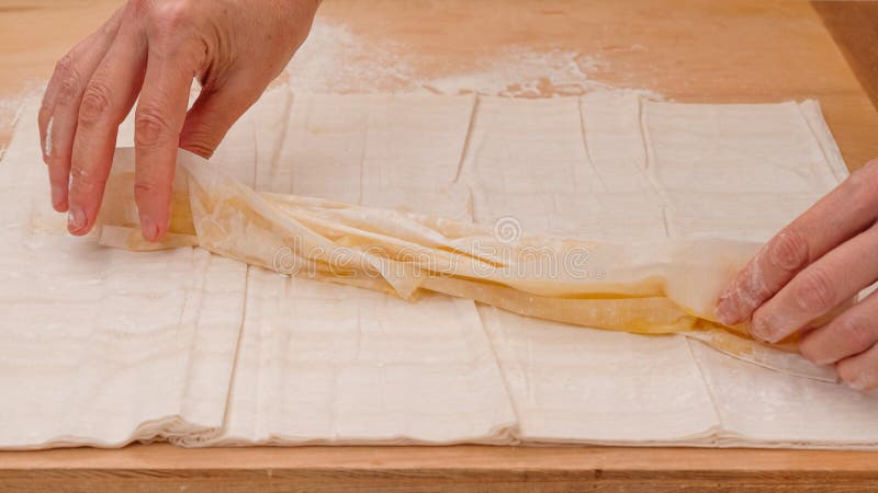 Chef Folding Buttered Layers of Phyllo Dough into Rolls Stock Photo ...