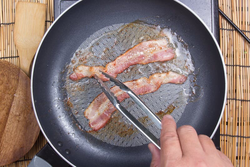 Chef Frying Bacon in the Pan Stock Photo - Image of cook, color: 85702954