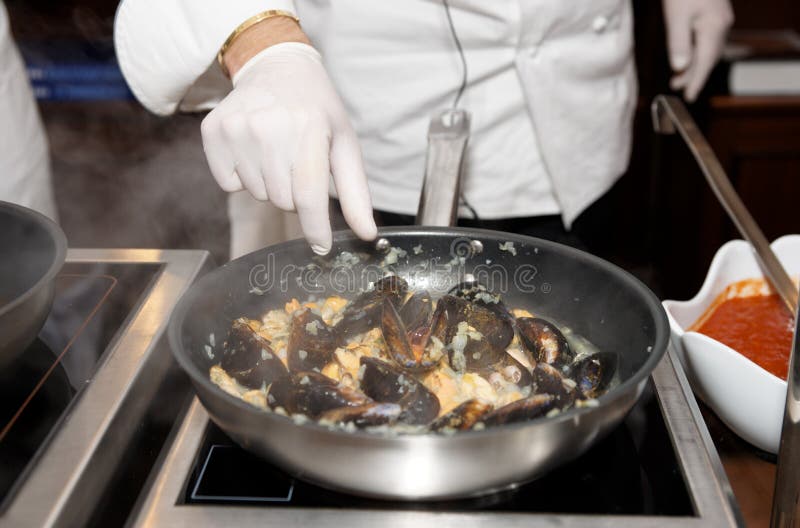 Chef frying mussels stock image. Image of chef, protective - 21586637