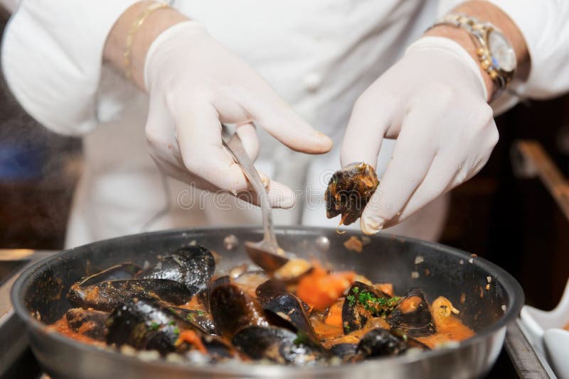 Chef frying mussels stock image. Image of health, cooking - 21586667