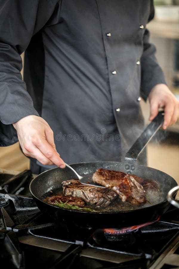 Chef frying pork meat stock image. Image of grilled, meat - 88018455