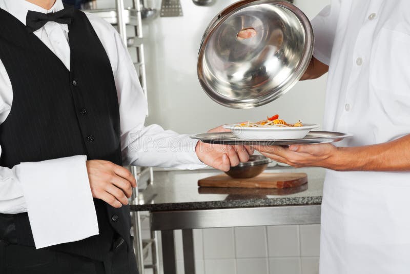 Waiter and Chef Using Digital Tablet in Kitchen Stock Photo - Image of ...
