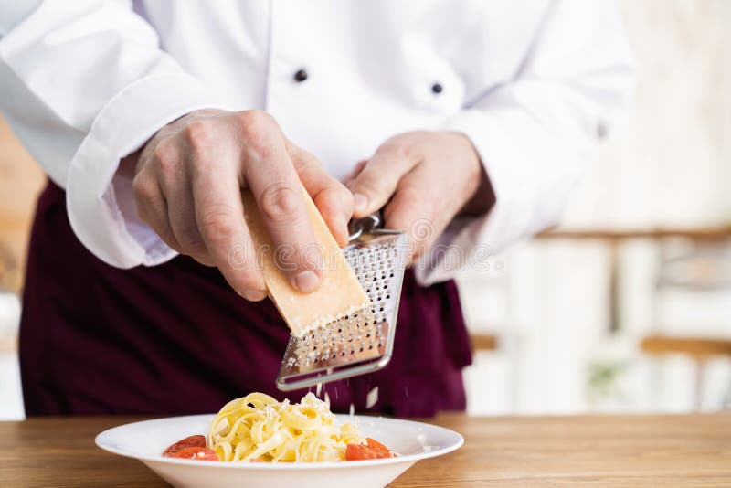 Chef Grates Cheese To the Plate with Fresh Pasta. Stock Photo - Image ...