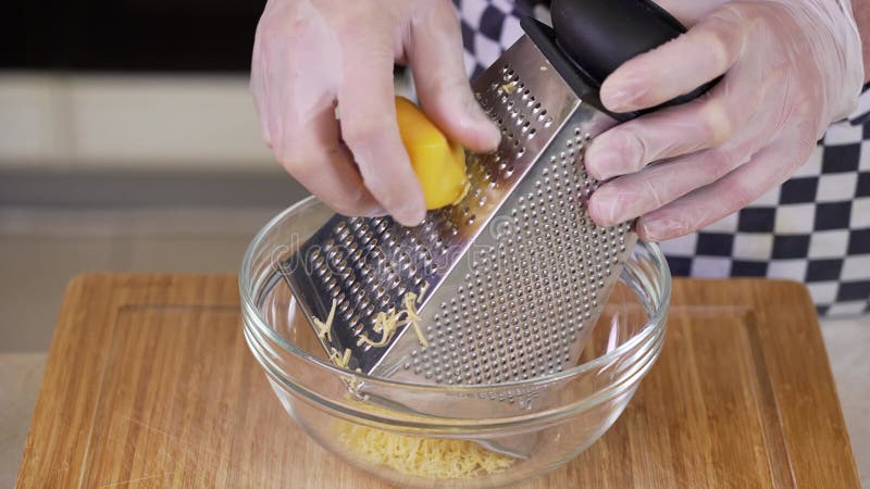 Grating Cheddar Cheese into a Glass Bowl Stock Footage - Video of ...