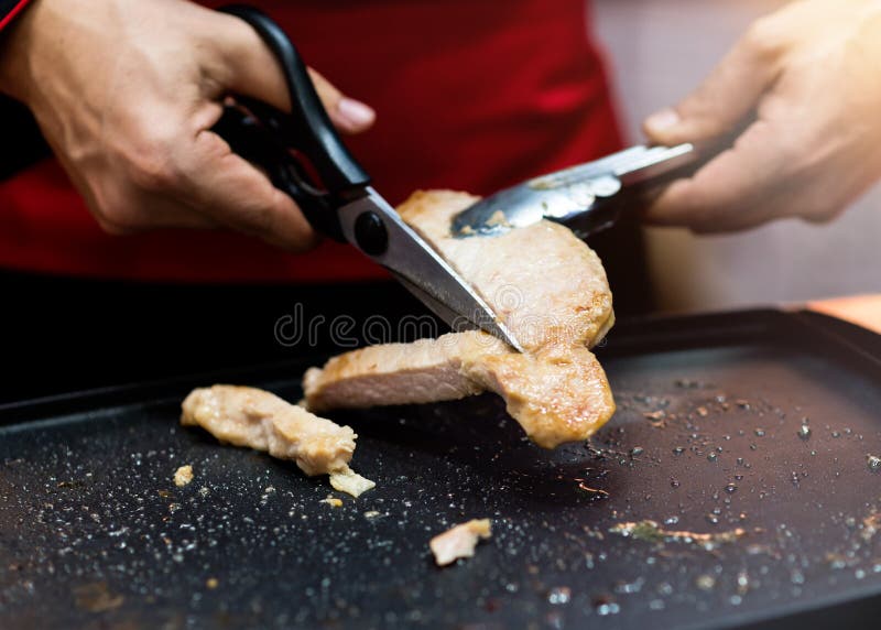 Chef is Grilled Pork Steak , Hand Hold Scissors Cutting Grilled Pork ...