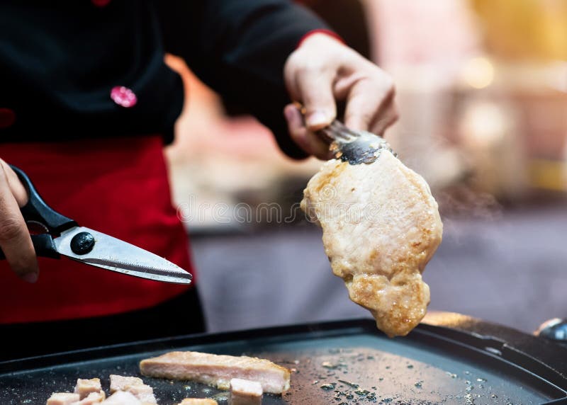 Chef is Grilled Pork Steak , Hand Hold Scissors Cutting Grilled Pork ...