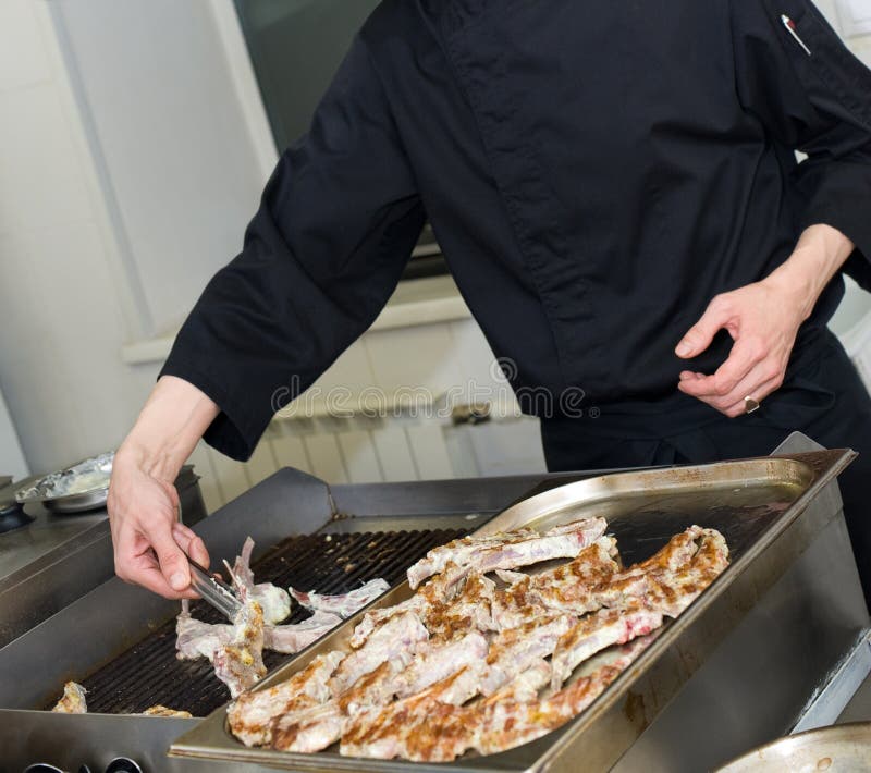 Chef grills meat stock photo. Image of browned, indoors - 23855810