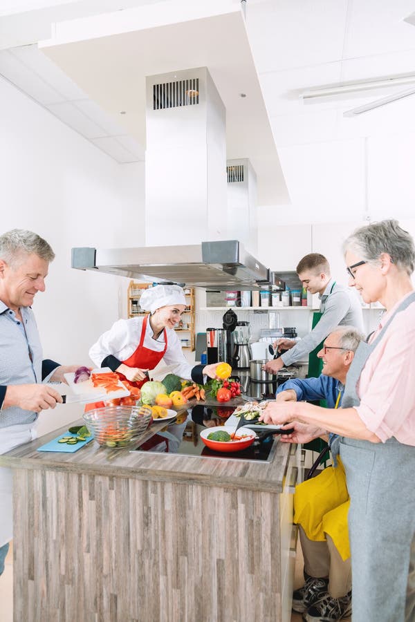 Chef and Group Cutting Vegetables and Cooking Together Stock Image ...