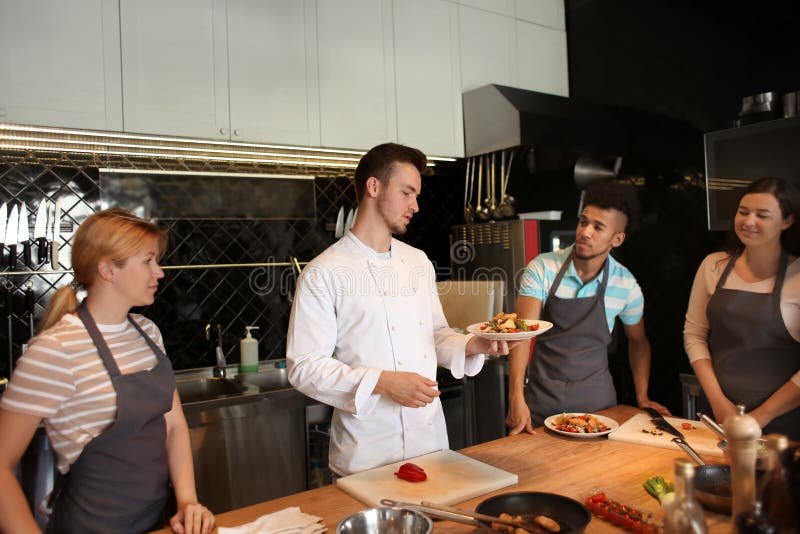Chef and Group of Young People during Cooking Classes Stock Photo ...