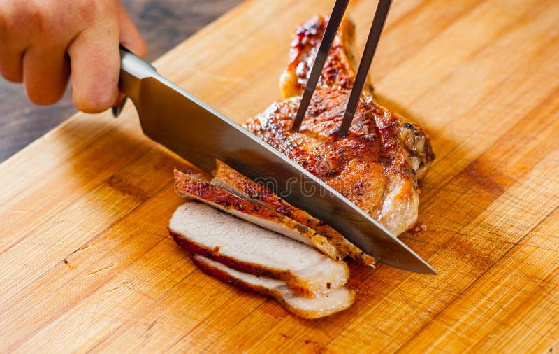Chef Hand with Knife Cutting Meat on Wooden Board. Stock Photo - Image ...