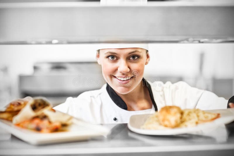 Chef Handing Dinner Dish To Waitress at Order Station Stock Photo ...